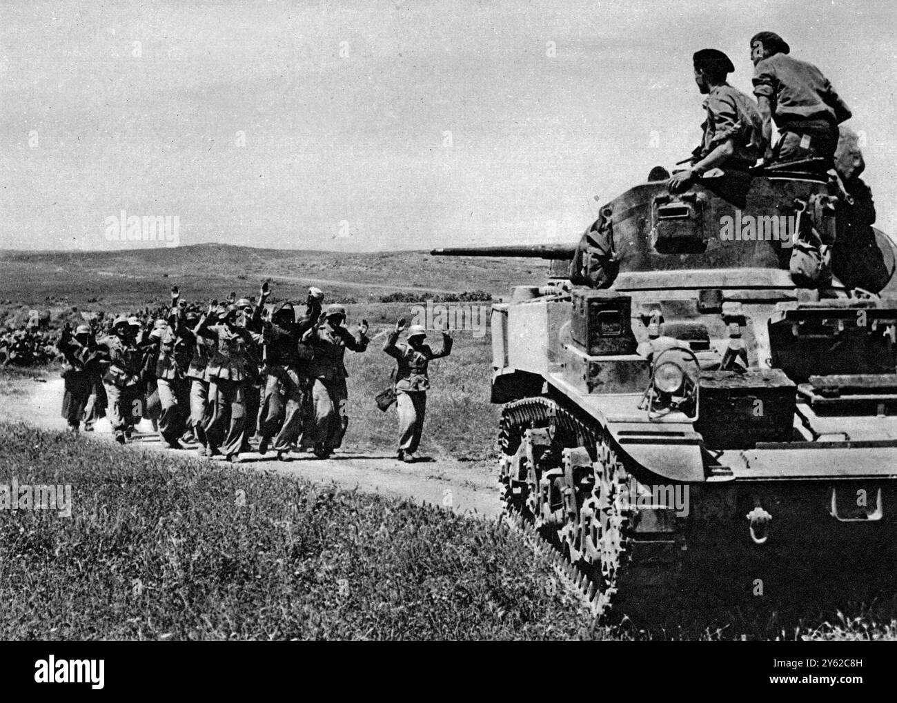 Germans, their hands held high in the air, hastening to surrender to a ...