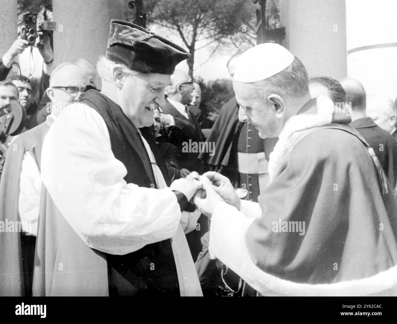 After exchanging kiss of peace Pope Paul VI (right) gives his ring to ...