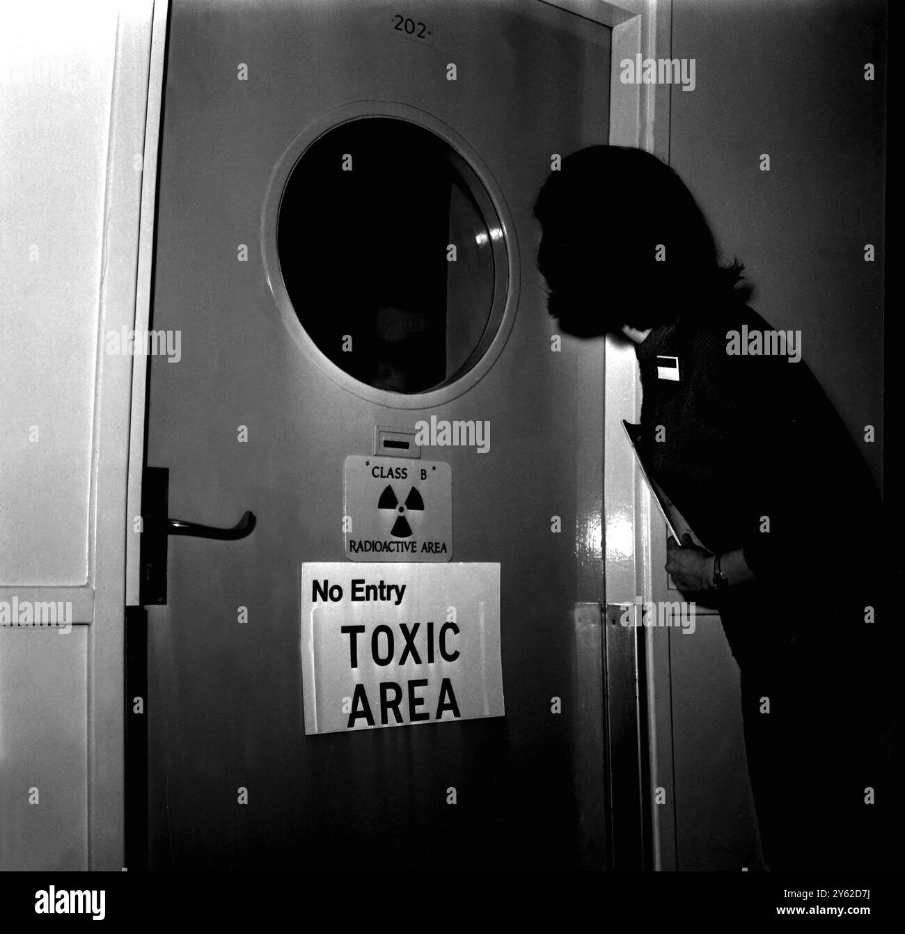 A visitor peeps through the window of a no entry laboratory during ...