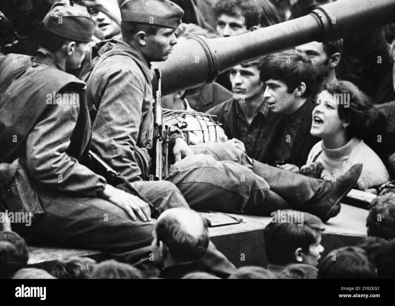 A young Czech girl shouts at the soldiers sitting smugly on their tank ...