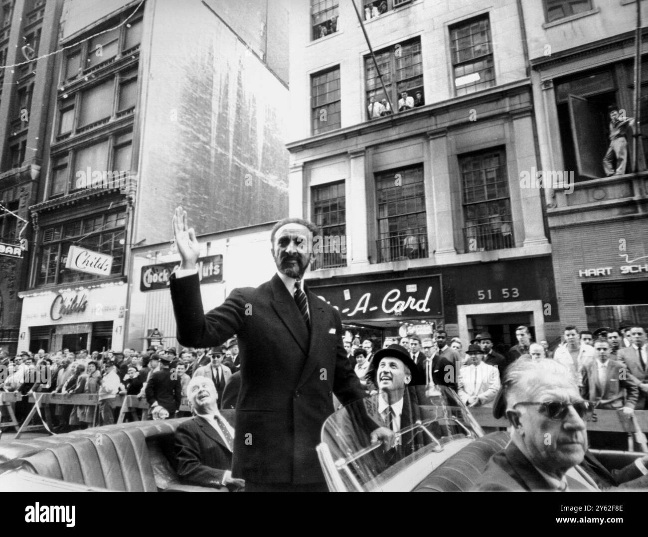 Ethiopian Emperor Haile Selassie stands in his car to wave to crowds as ...