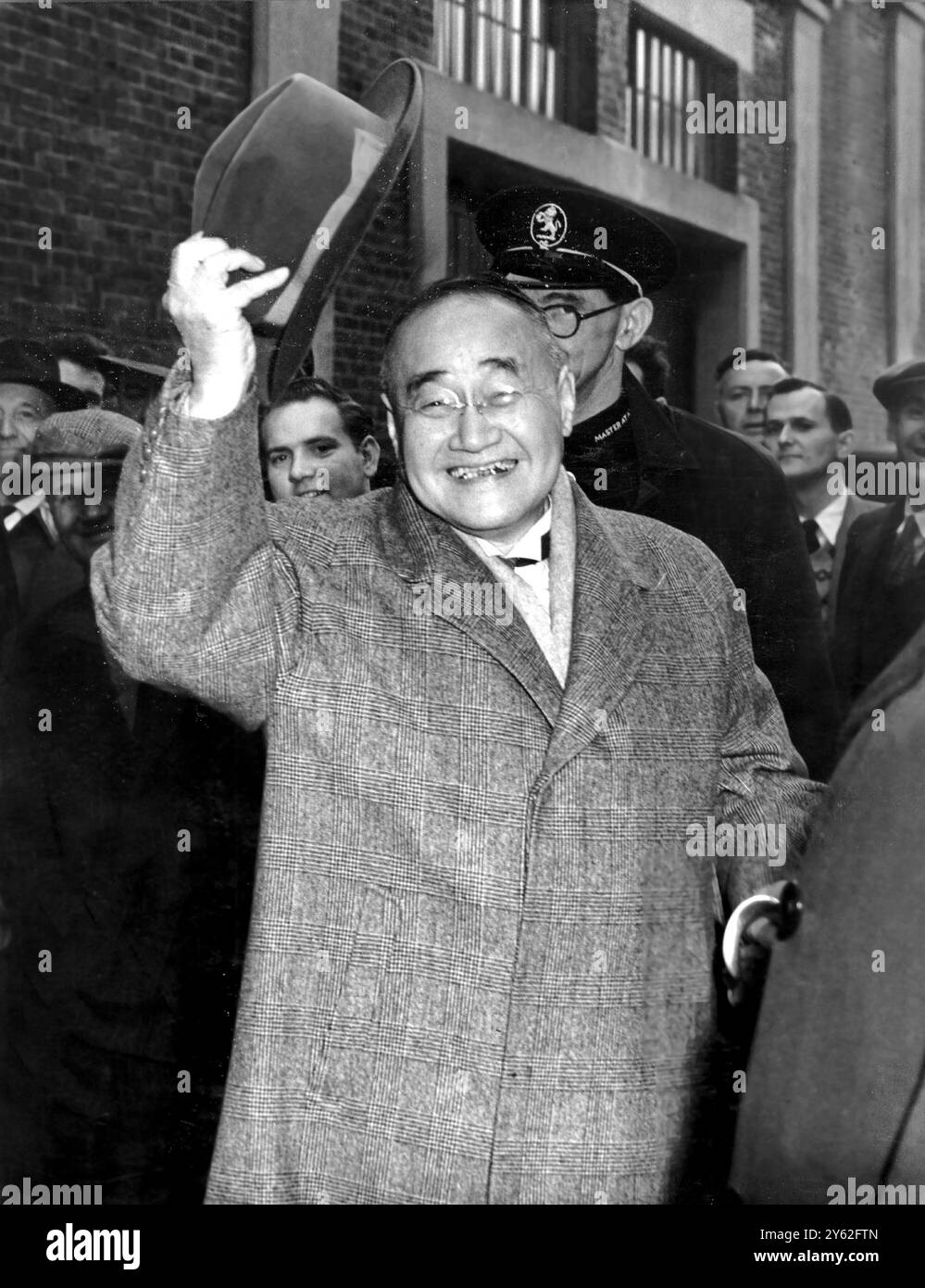 A final wave of his hat from Japanese Prime Minister Mr Shigeru Yoshida ...