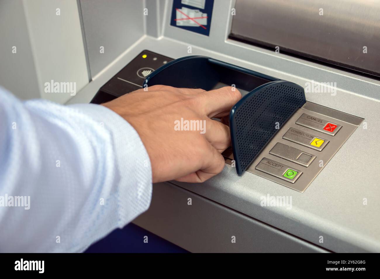 ATM machine and close-up man hand pushing on the pin button. Hand ...
