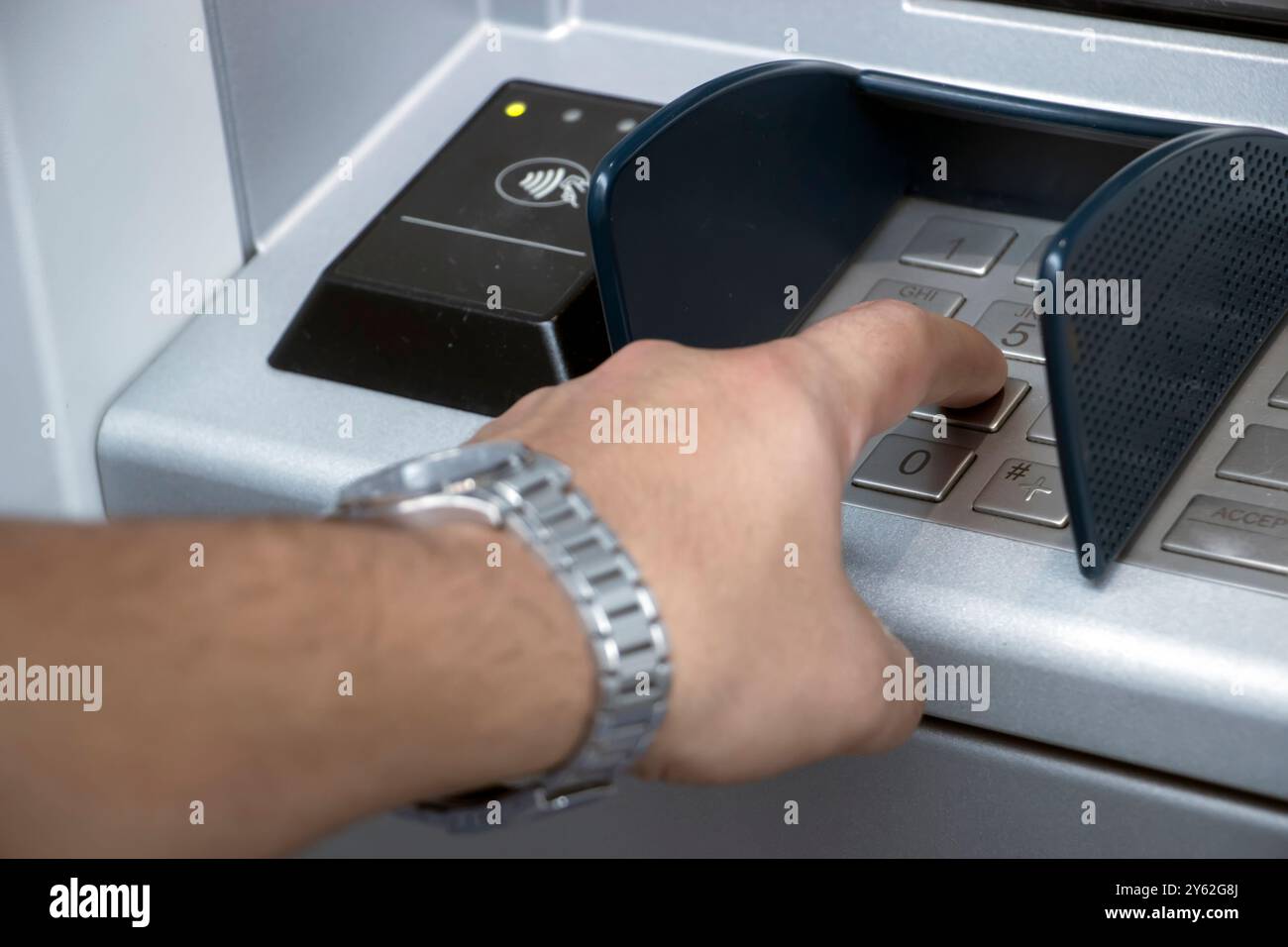 ATM machine and close-up man hand pushing on the pin button. Hand ...