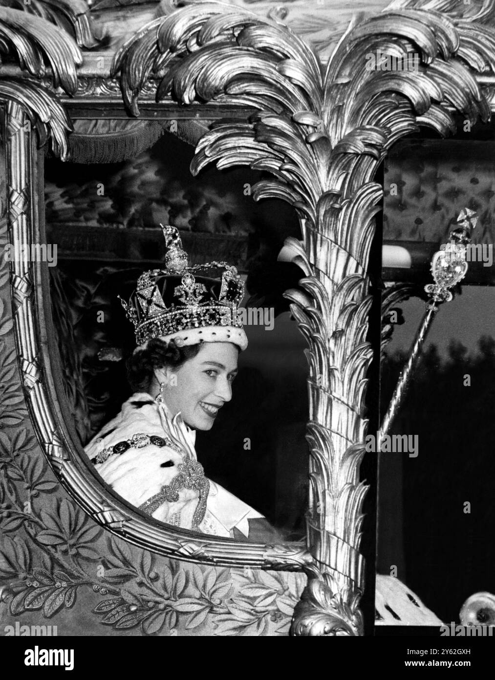 The Queen rides in the golden State Coach into Buckingham Palace at the ...