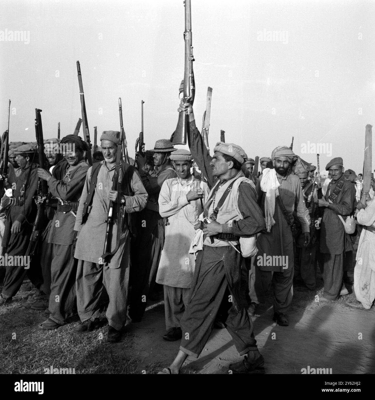 A group of the famed Pathan fighters of Pakistan raise their rifles in ...