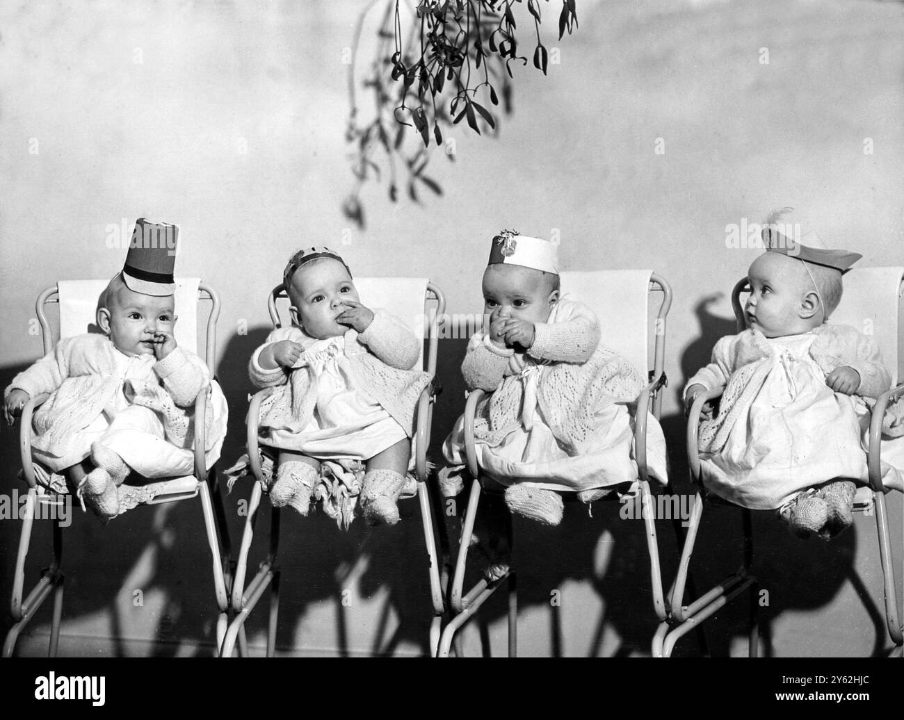 The four charming young ladies sitting coyly under the mistletos are ...