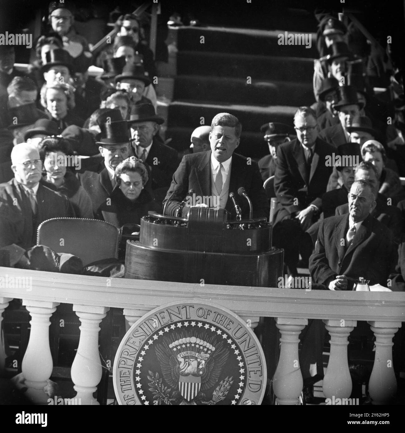 President John Kennedy makes his inaugural speech after being sworn in . Listening are Mrs ...