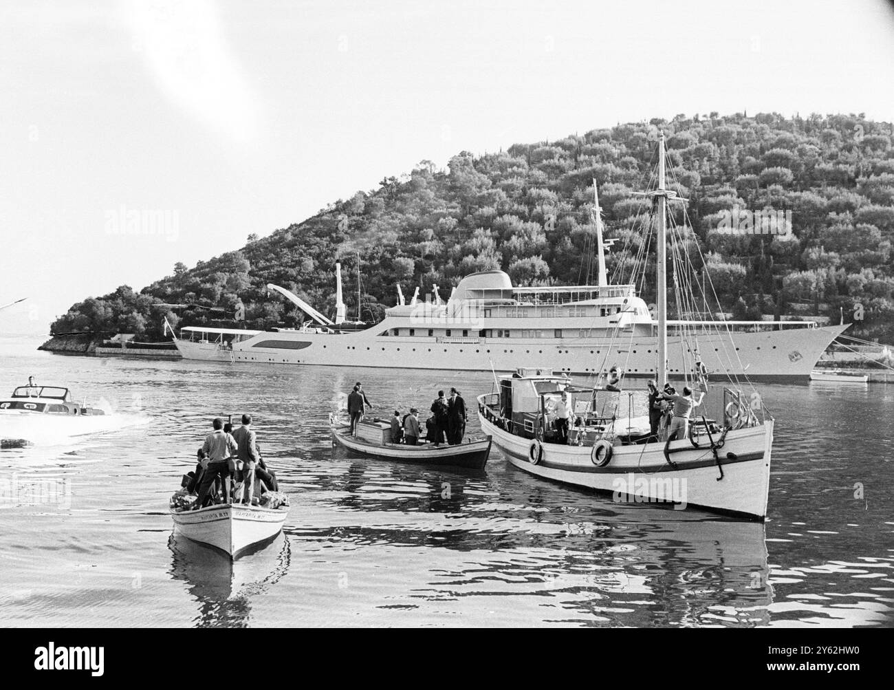 Boatloads of newsmen and press photographers approach the Onassis yacht ...