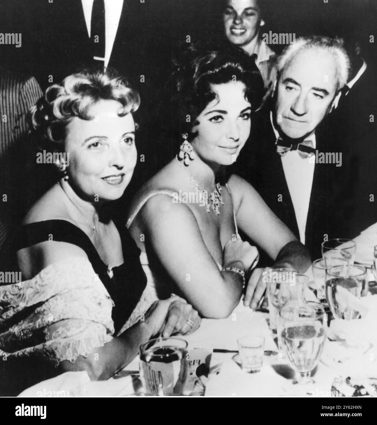 Actress Elizabeth Taylor sits with her mother and father in a night ...