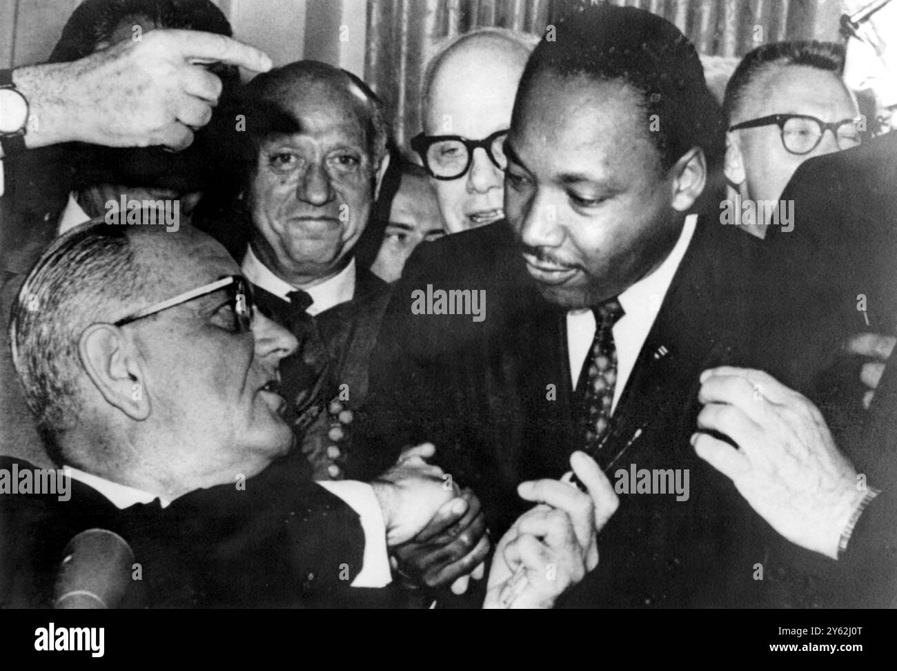 US president Lyndon B Johnson (left) shakes hands with civil rights ...