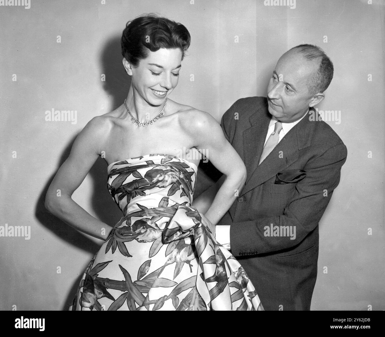 Christian Dior, the Paris fashion designer, with model Dorothy Emms. For the first collection to ...