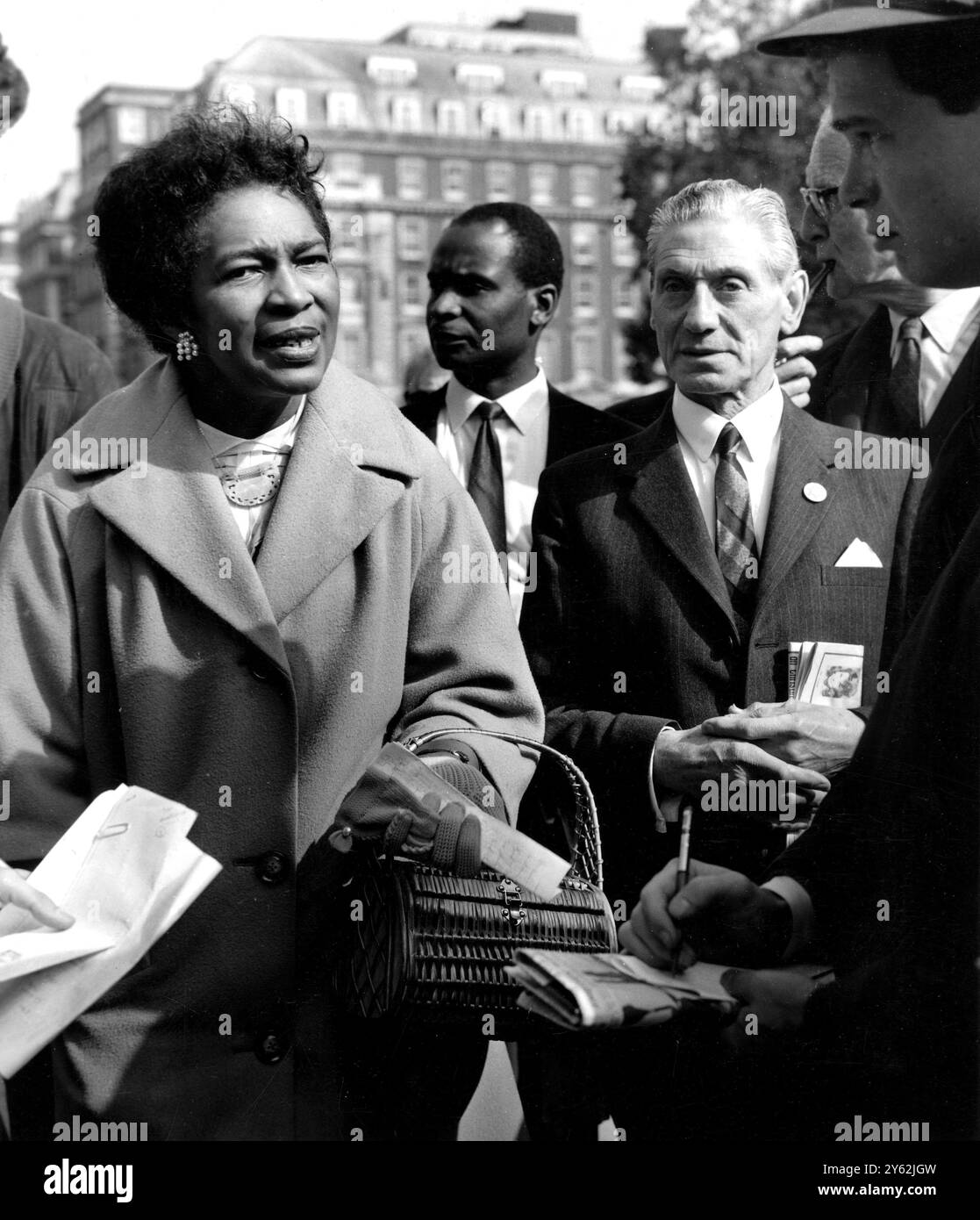 Miss Claudia Jones is shown talking to reporters outside the US Embassy ...