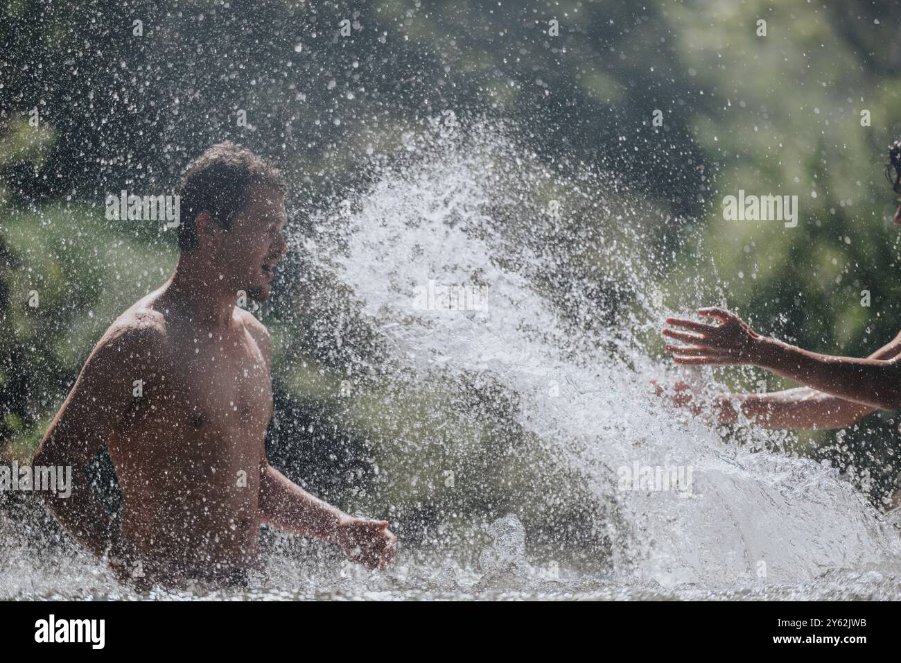 Refreshing water splash fun in the great outdoors Stock Photo - Alamy