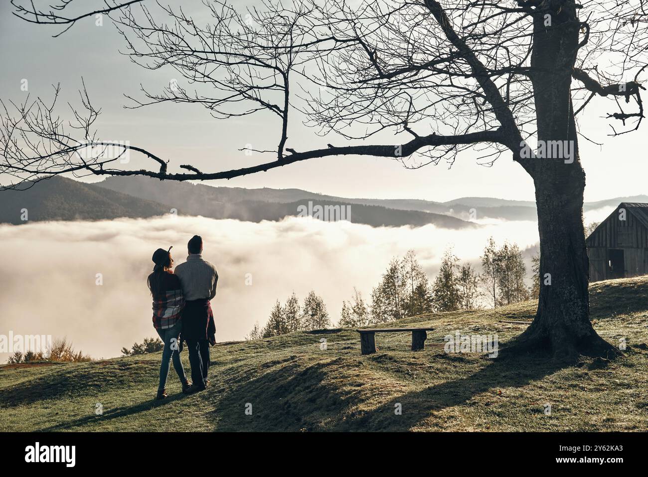 Perfect day together. Full length rear view of young couple embracing ...