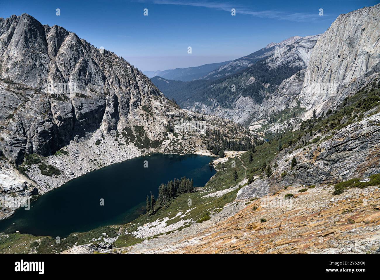 Alpine lake surrounded by granite mountains along High Sierra Trail ...