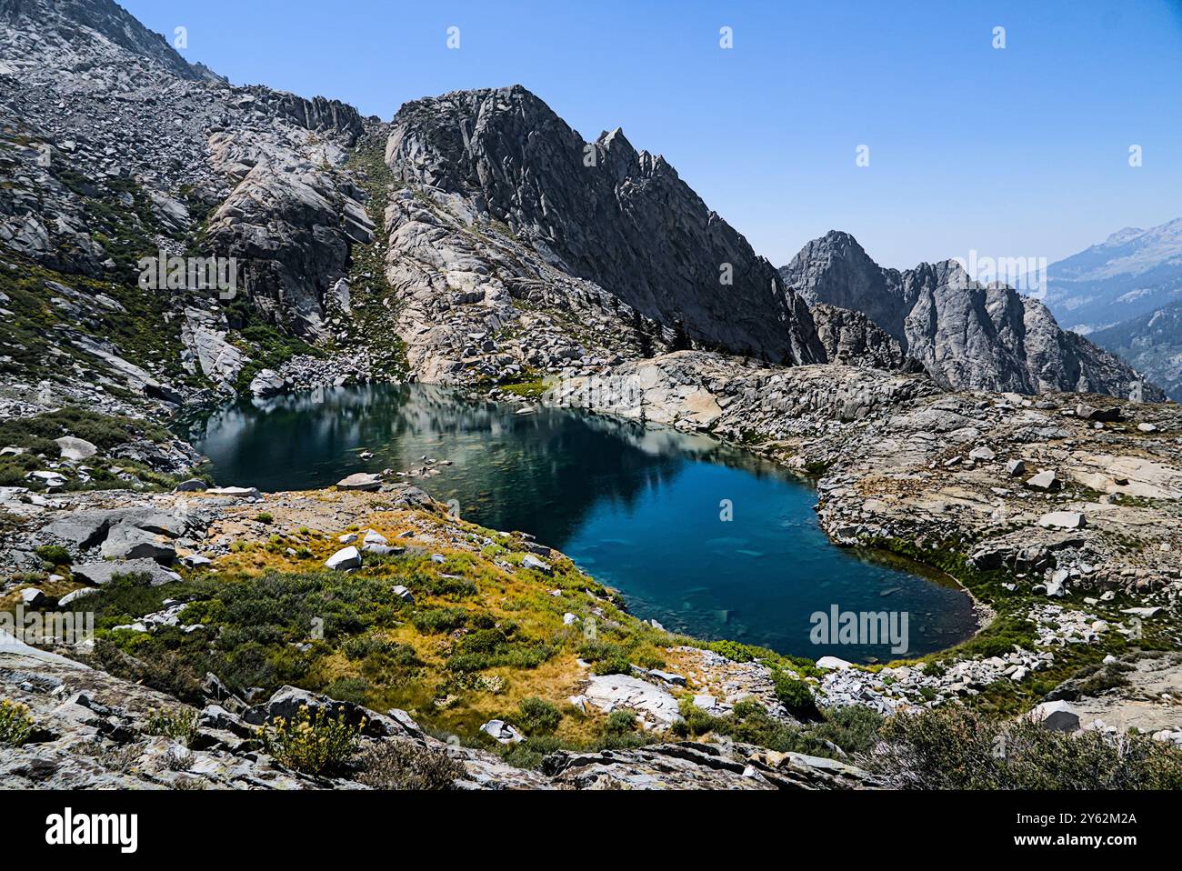 Alpine lake surrounded by granite mountains along High Sierra Trail ...