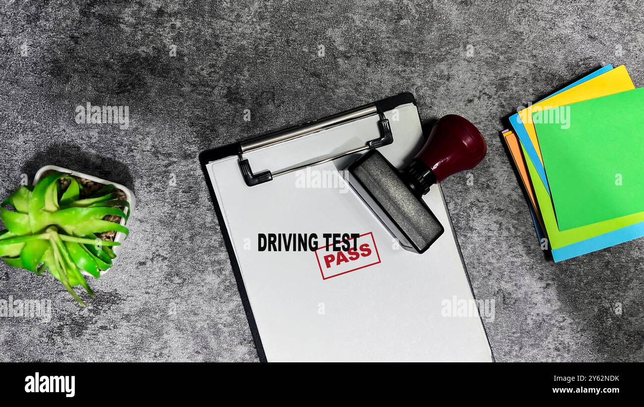 Red Handle Rubber Stamper and Driving Test Pass text on a paperwork ...