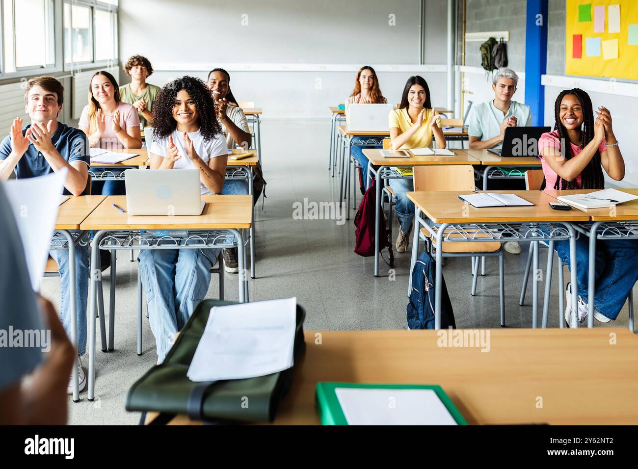 Students applauding to their classmate after giving a presentation in ...