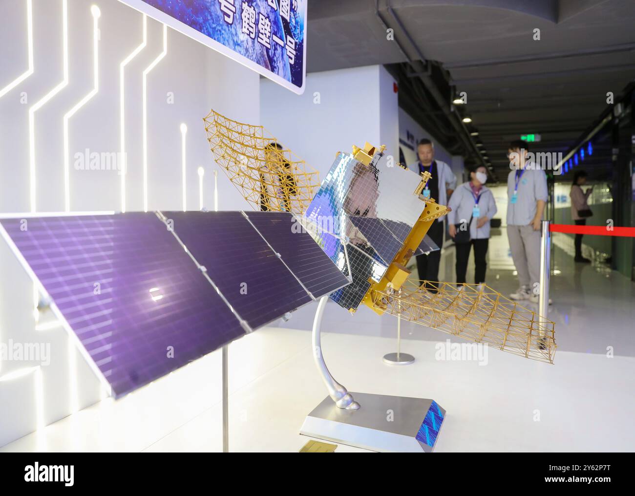 HEBI, CHINA - SEPTEMBER 23, 2024 - Visitors look at a model of a ...