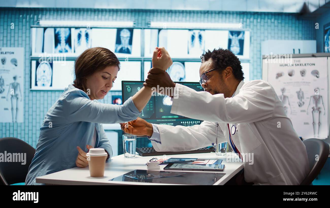 General practitioner examining x ray scan test results with patient ...