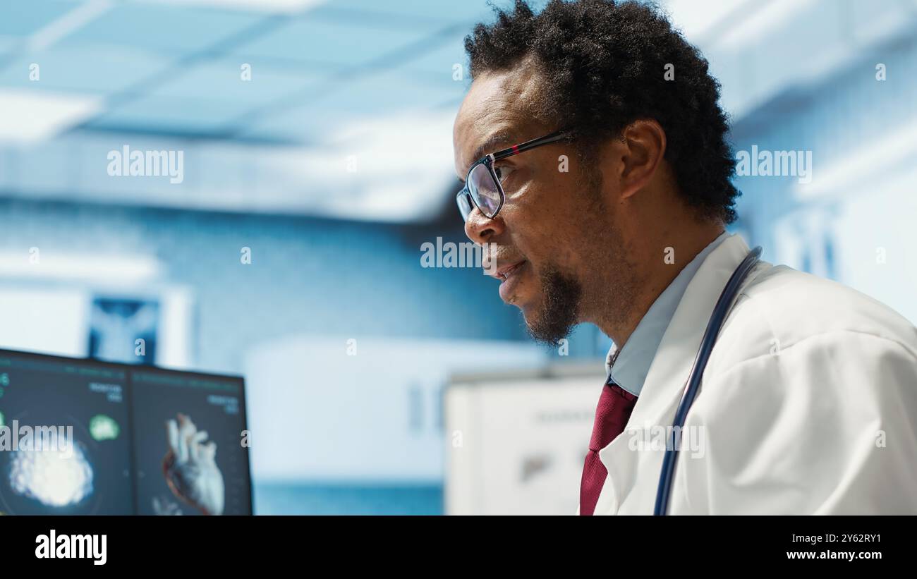 Male physician doing an x ray diagnostics scan interpretation during ...