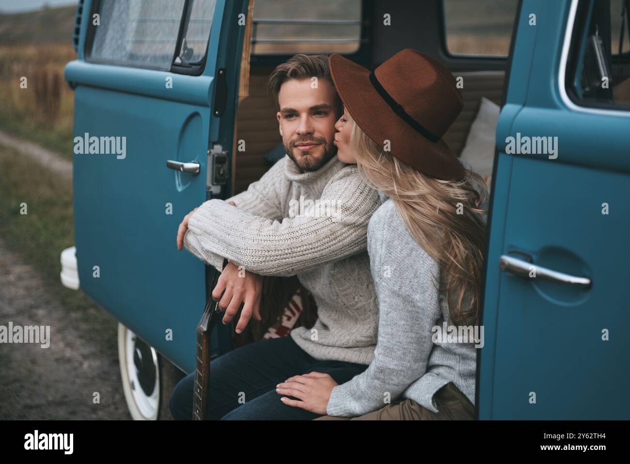 Kiss filled with love. Beautiful young woman kissing her boyfriend ...