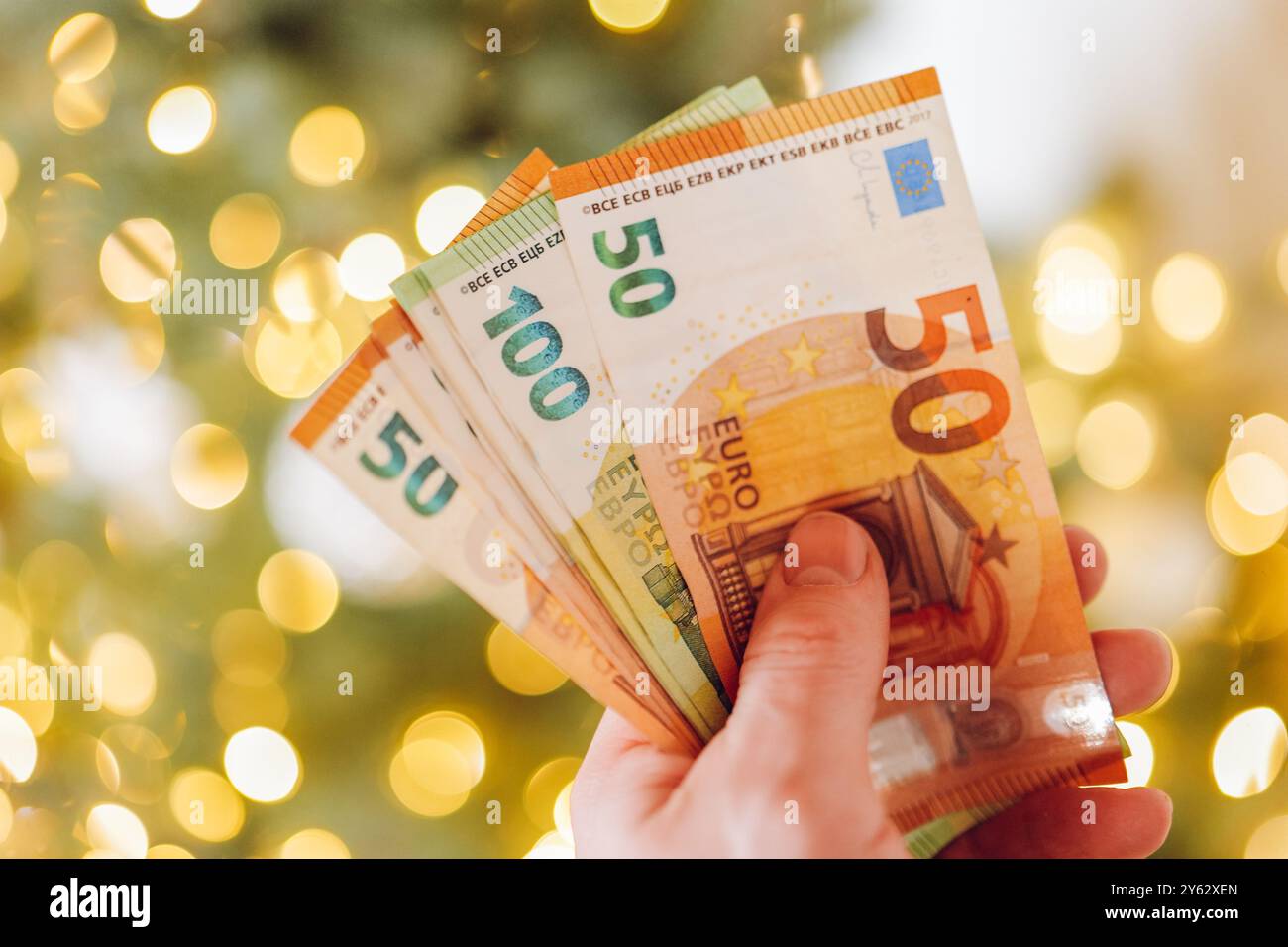 Christmas Holiday Expenses.Euro banknotes and Christmas tree.Christmas ...