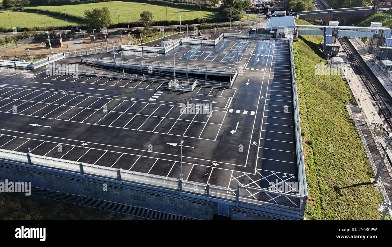 Aerial view of an empty multi-level parking structure next to a railway ...