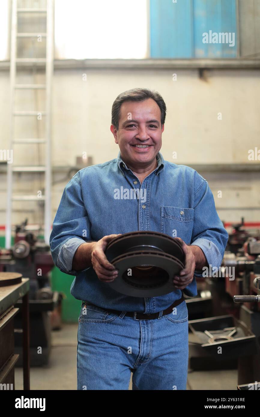 Mechanic loads brake discs ready for installation Stock Photo - Alamy