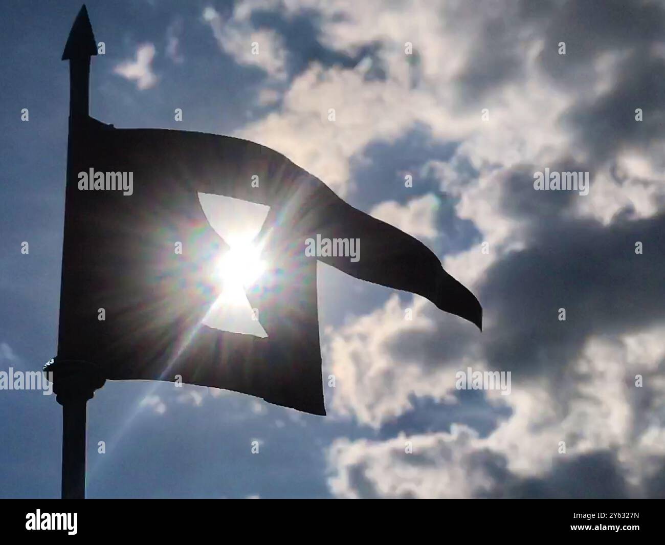 A pennant with a chalice as symbol of Hussite, against the sun rays ...