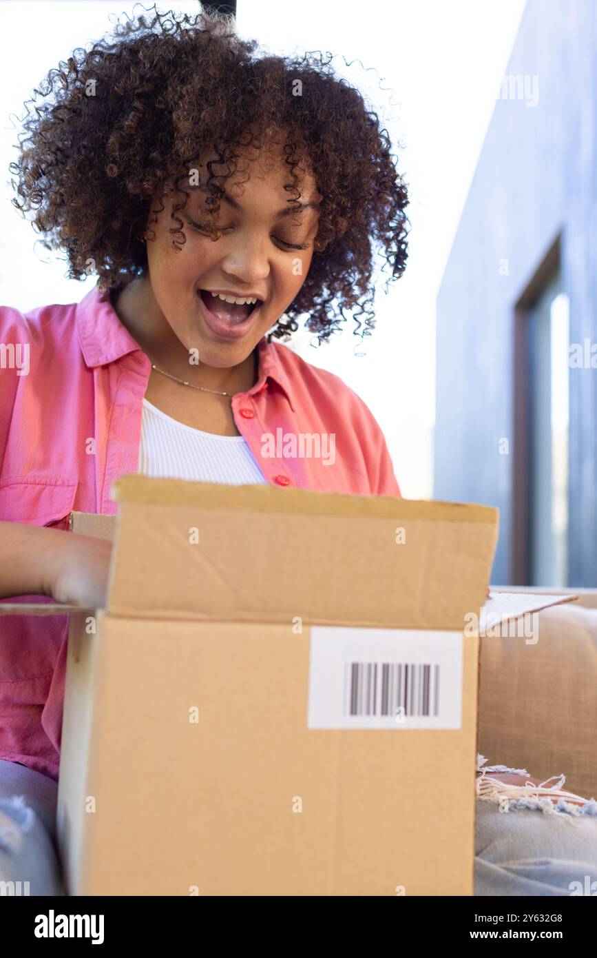 Opening cardboard box, woman excitedly discovering contents inside at ...