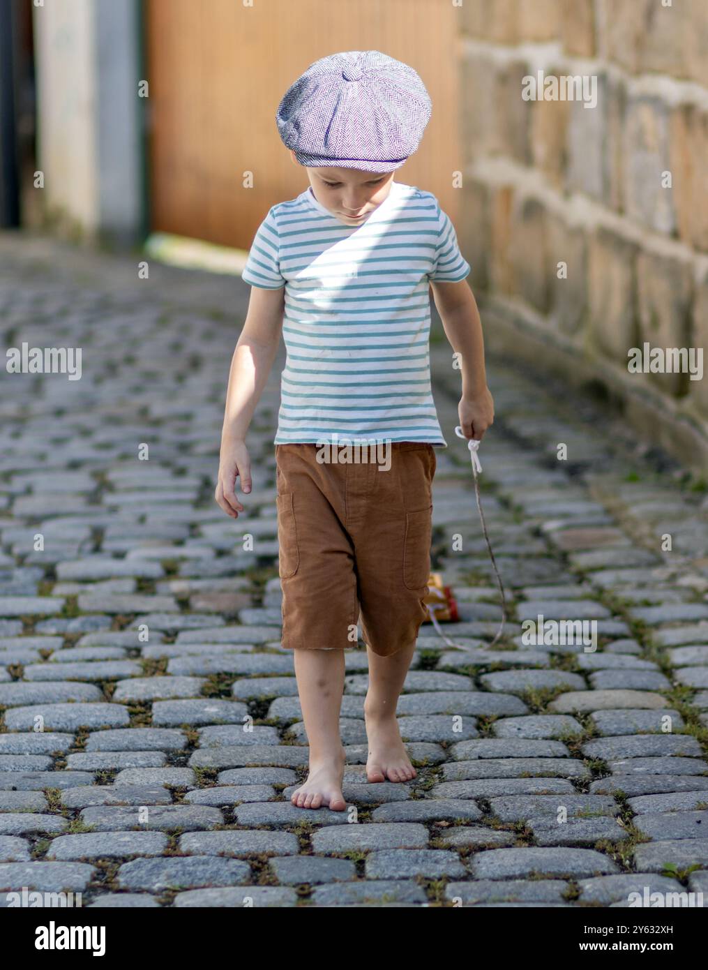 A little boy pulls a wooden cart on the street Stock Photo - Alamy
