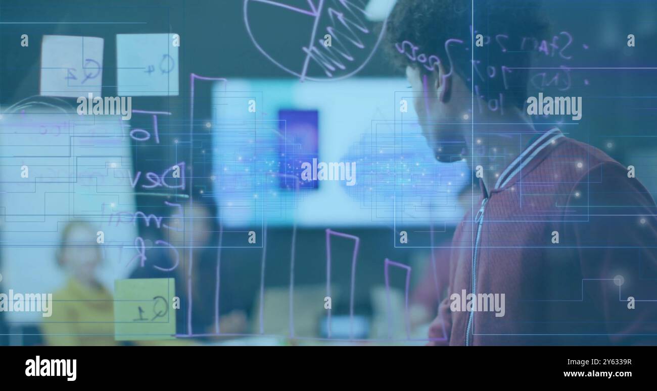 Writing on transparent board, young professional over digital data ...