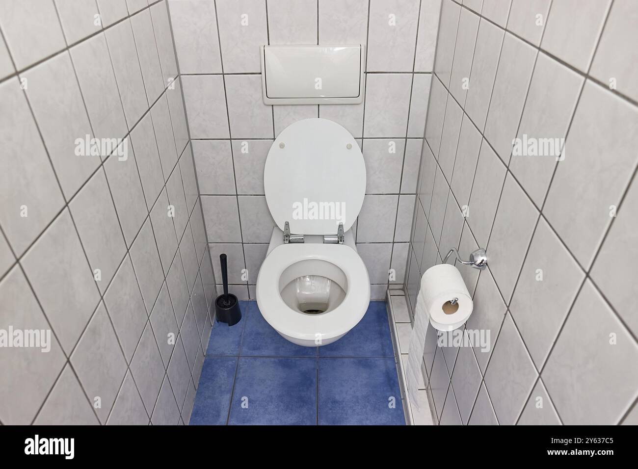 Toilet seat open, tiled restroom Stock Photo - Alamy