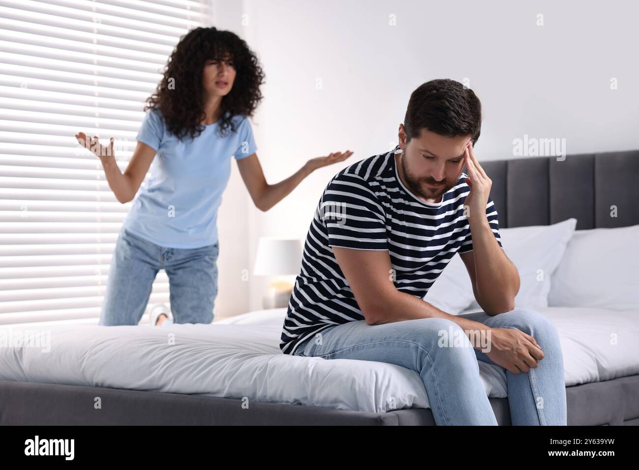 Emotional couple having quarrel in bedroom, selective focus ...
