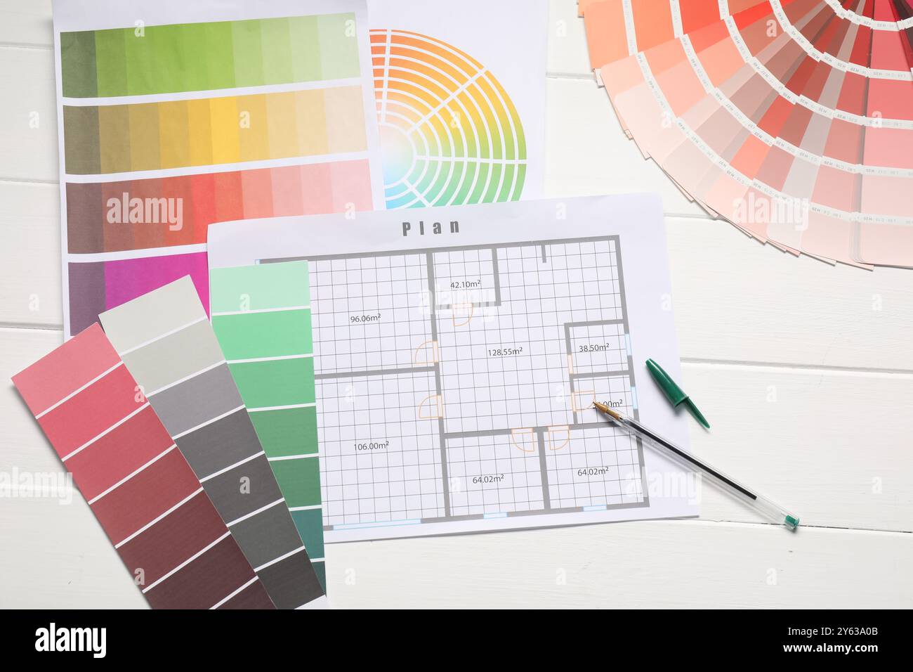 Designer's workplace with color palettes, floor plan and pen on white ...