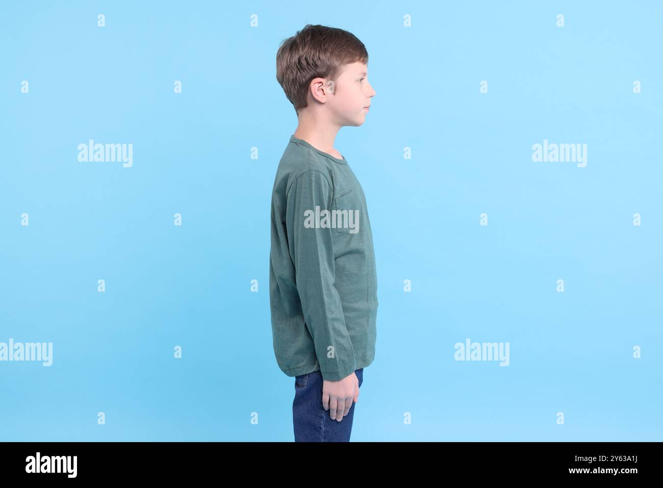 Boy with correct posture on light blue background Stock Photo - Alamy