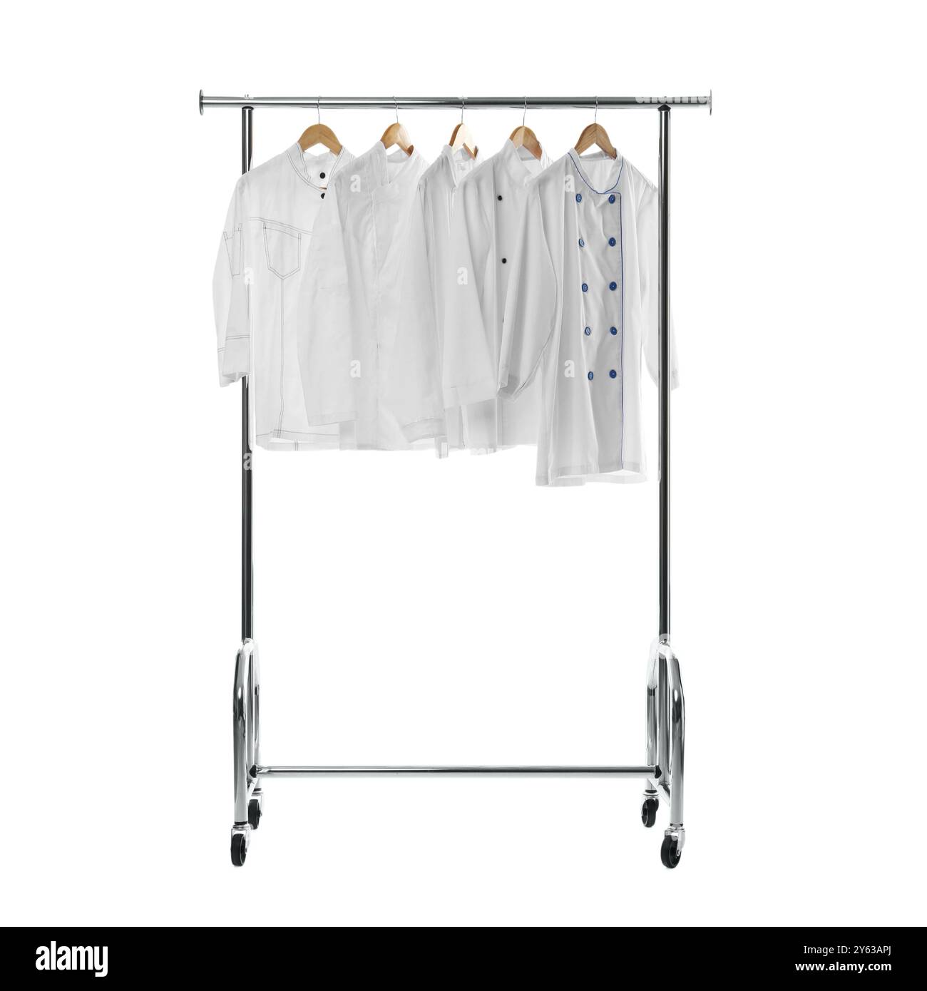Different chef's coats on clothing rack against white background Stock ...