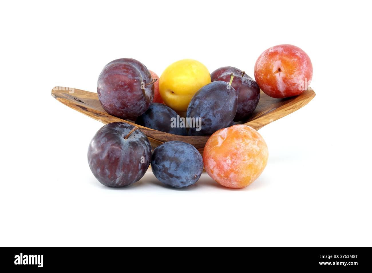 Variety of fresh plums in a wooden bowl showcasing vibrant colors ...