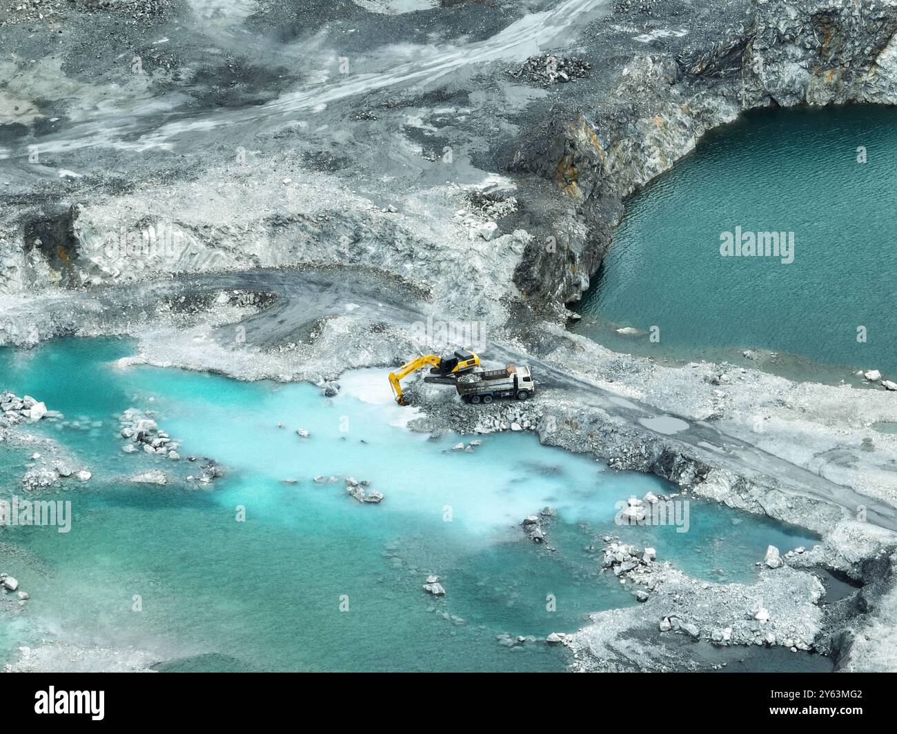 Open pit mine industry. Limestone quarry with backhoe and truck in ...