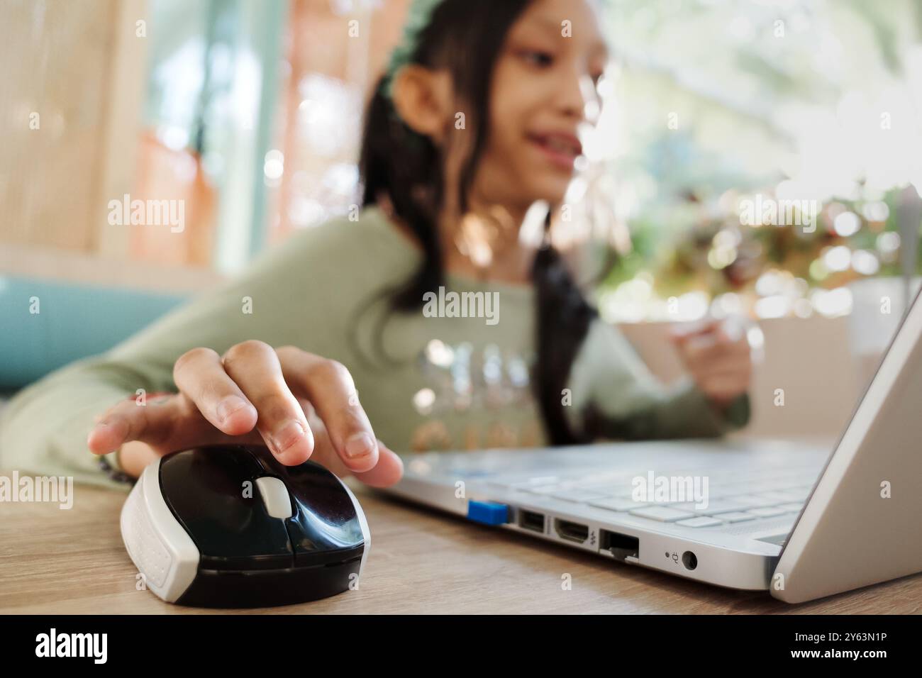 Asian teen girl smiling while communicating with friend through ...