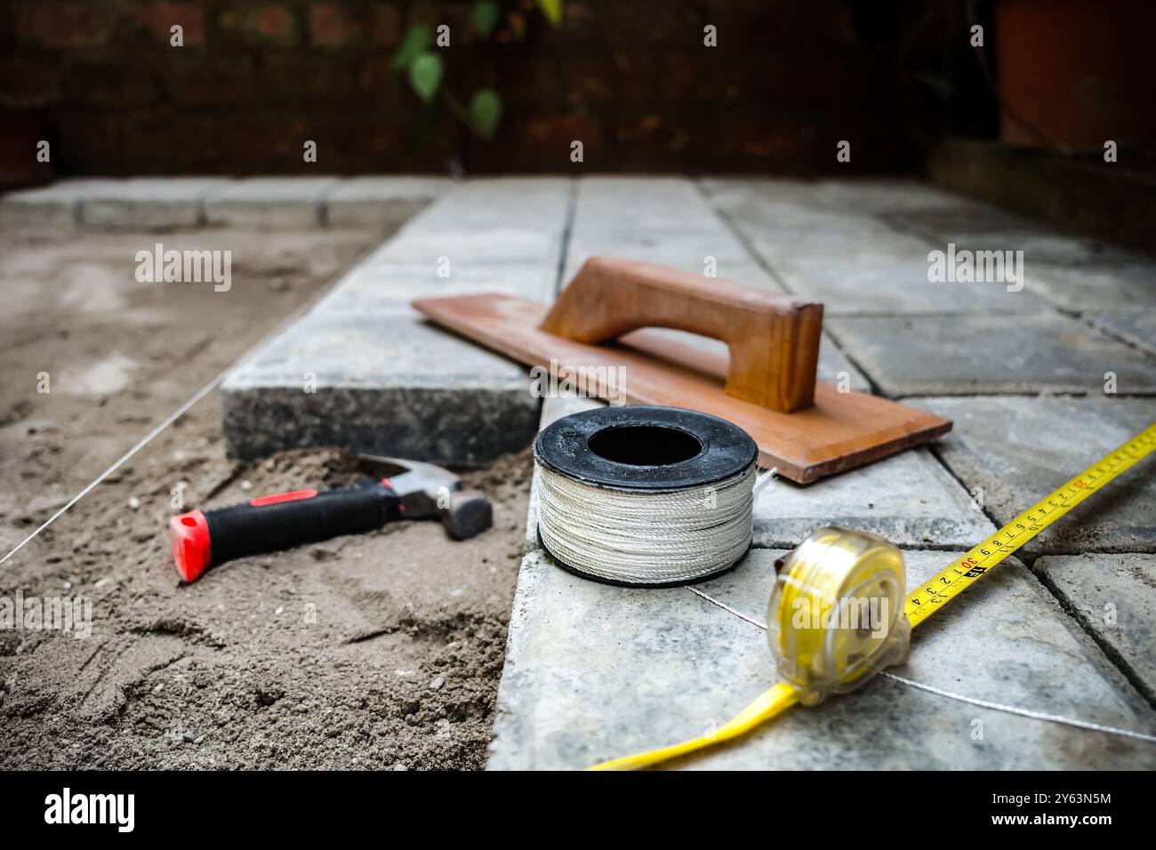 Closeup view of tools used for paving block floor construction work for ...