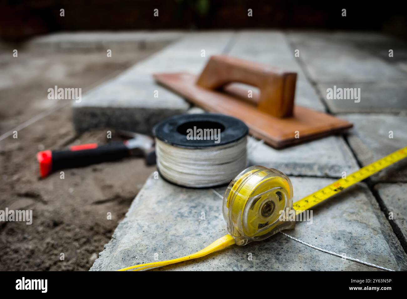 Closeup view of tools, utensils and materials used for paving block ...
