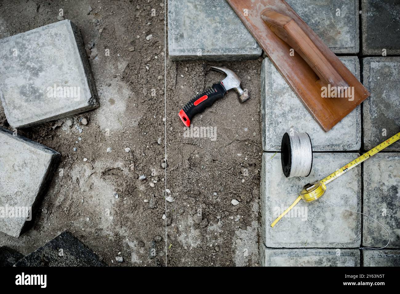 Top view of paving block floor construction work with tools for home ...