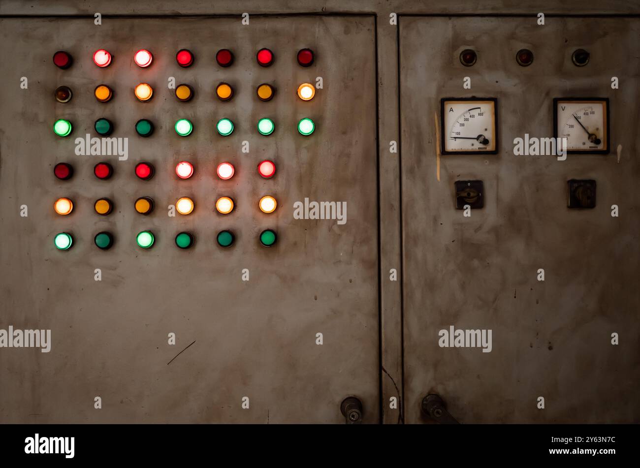 Dirty old and rustic electrical control panel with red, green and ...