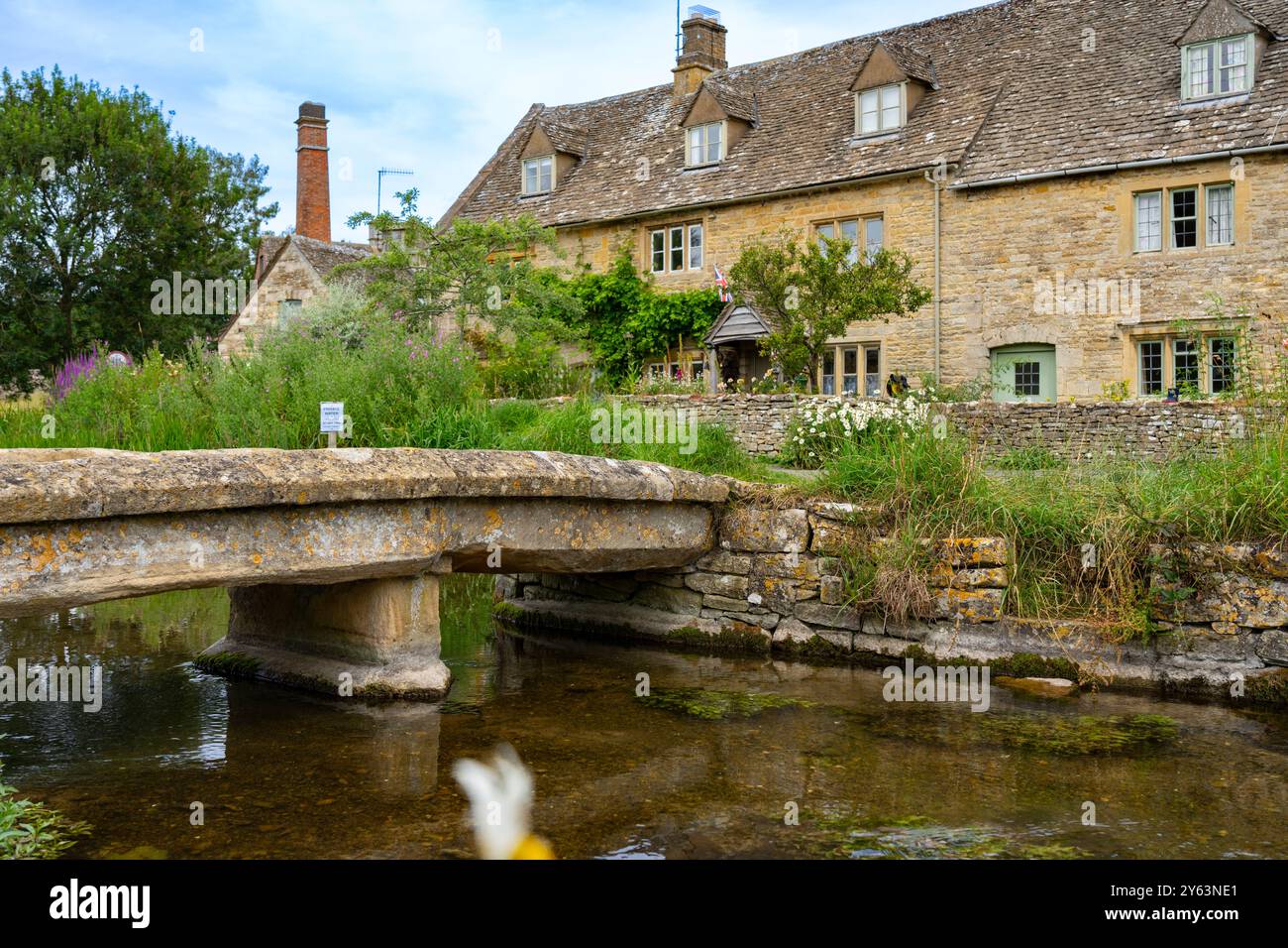 Low stone bridge across stream in small English village of Lower ...