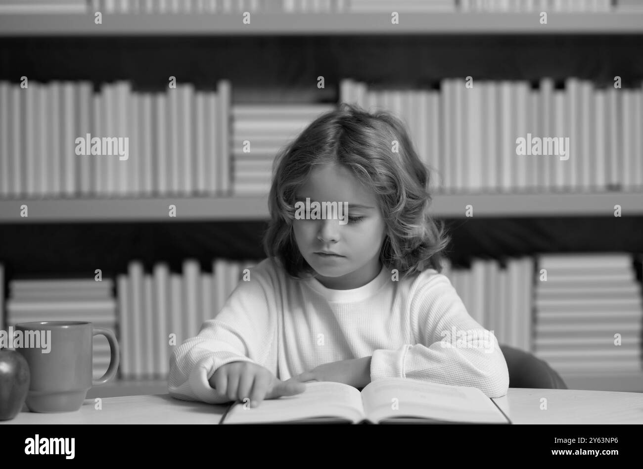 Intellectual child, clever pupil. Little student on school library ...