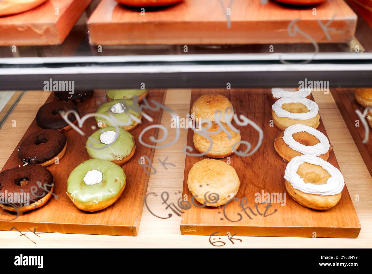 Donuts of various flavors and toppings displayed at a local food stall ...