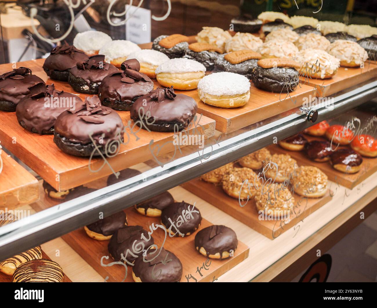 Donuts of various flavors and toppings displayed at a local food stall ...
